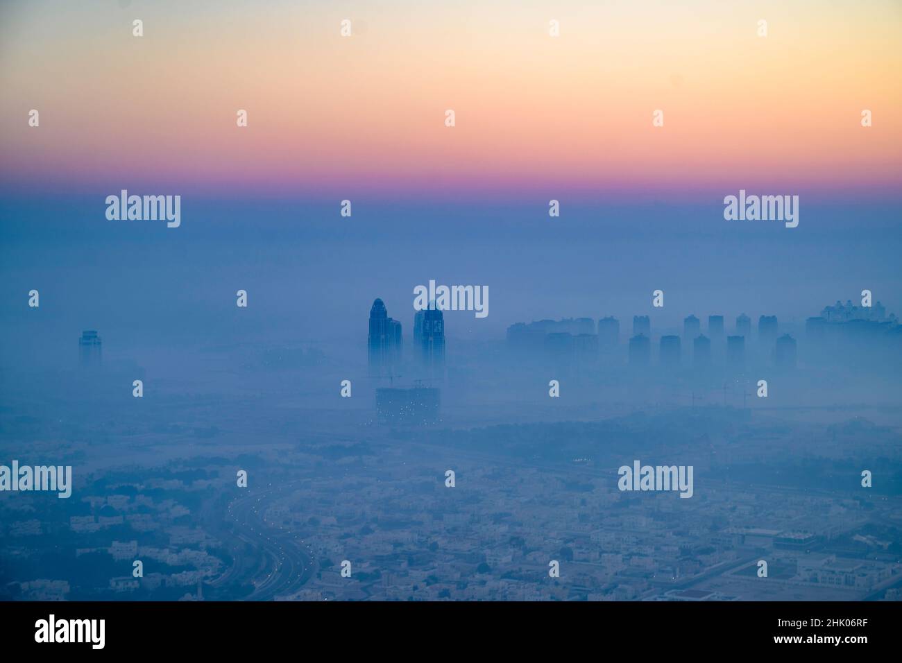 Doha The Pearl at sunrise with morning fog Stock Photo - Alamy