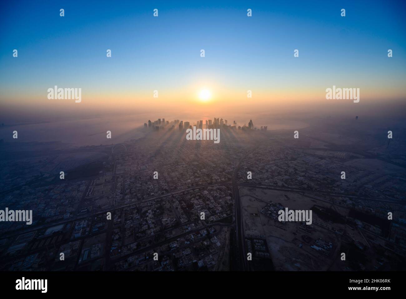 Doha skyline at sunrise with morning fog Stock Photo - Alamy