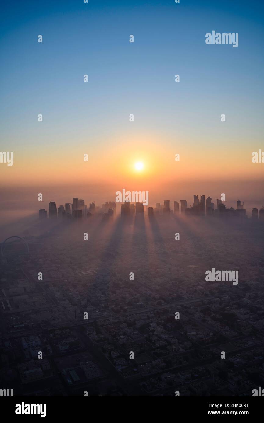 Doha skyline at sunrise with morning fog Stock Photo - Alamy