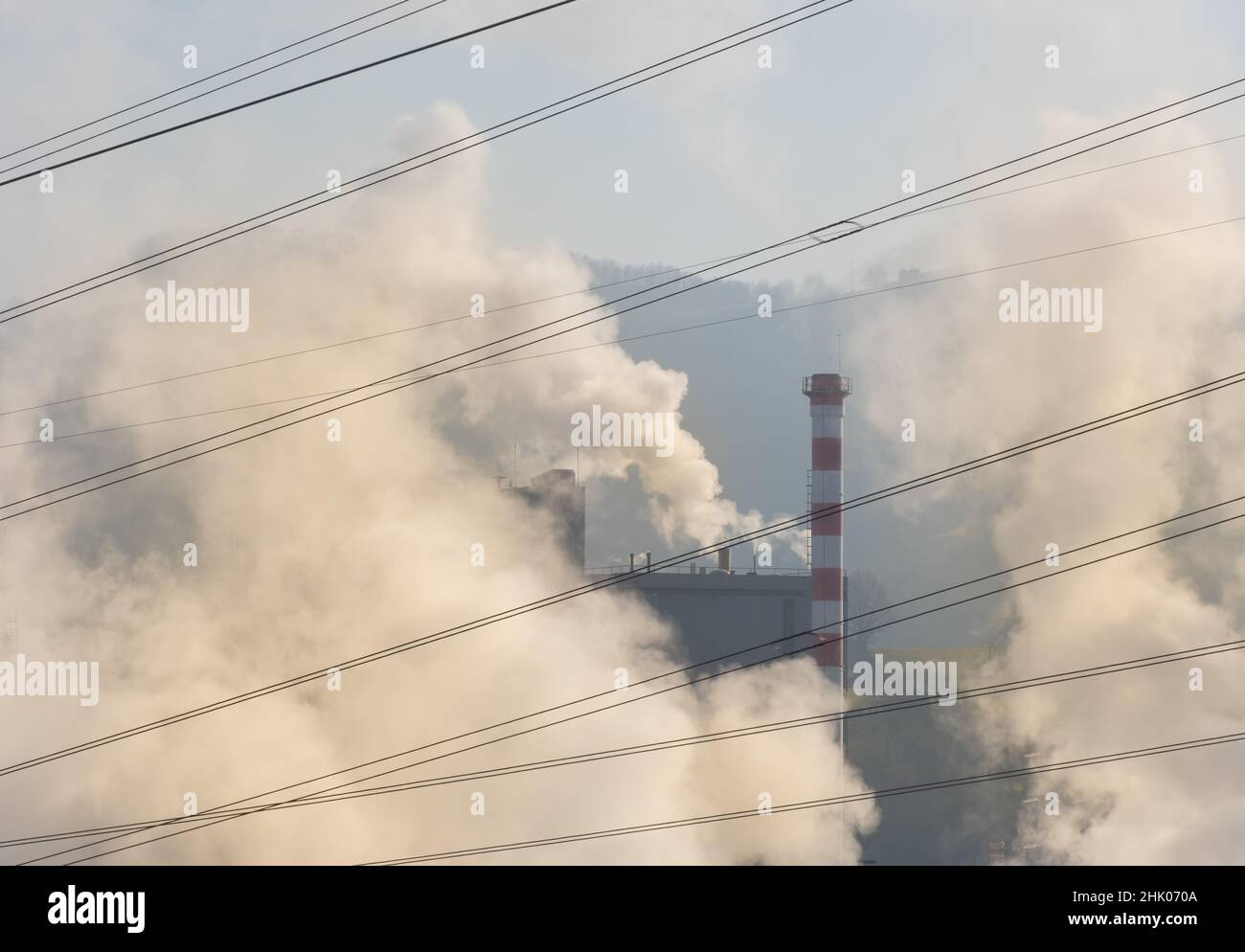 Fumes and pollution in factory chimneys Stock Photo - Alamy