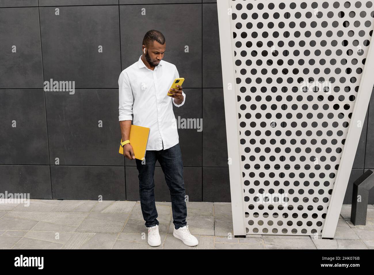 Concentrated stylish business guy wearing casual outfit, using ...