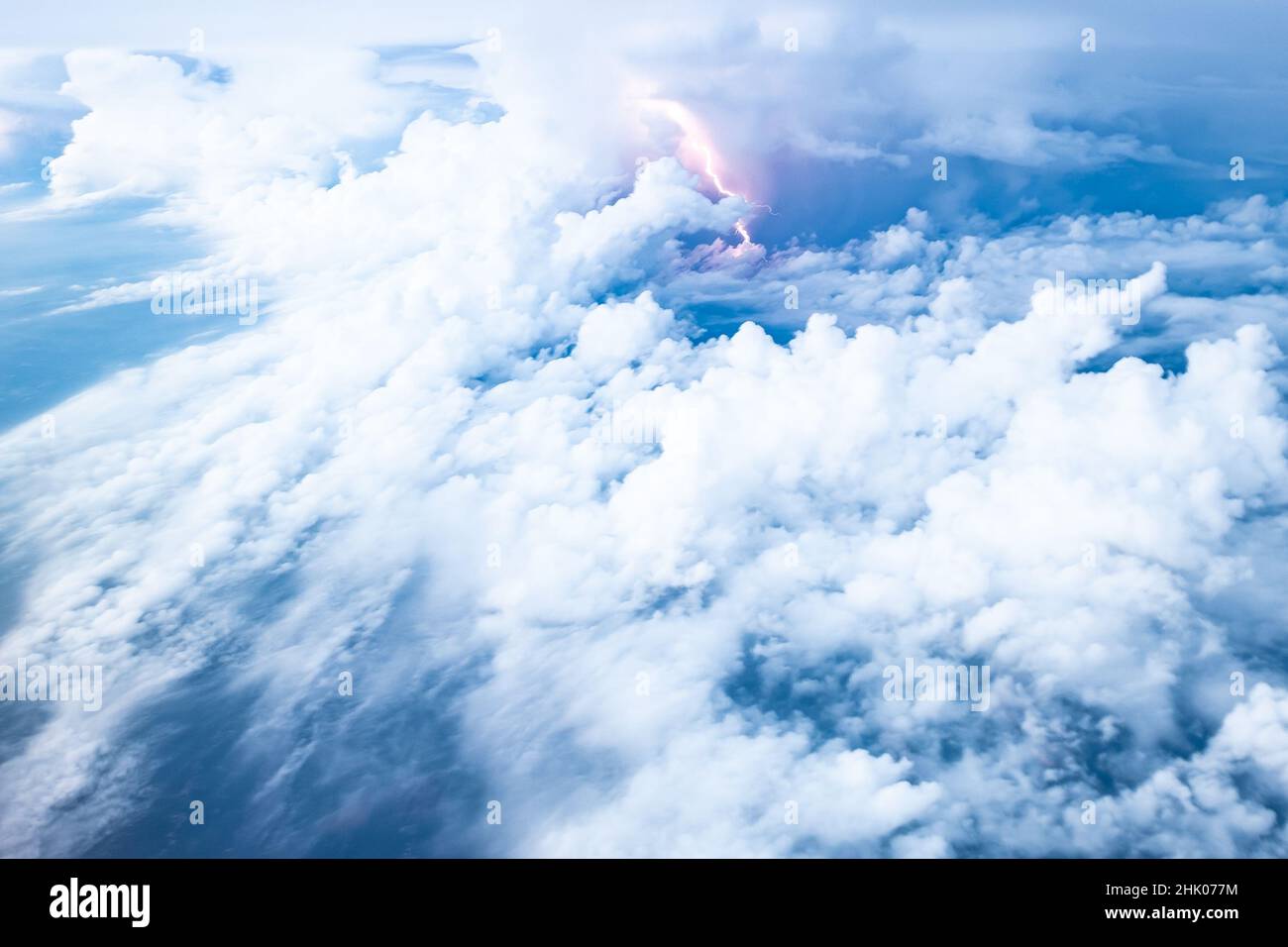 A bolt of lightening viewed from the window of an airline place at high ...