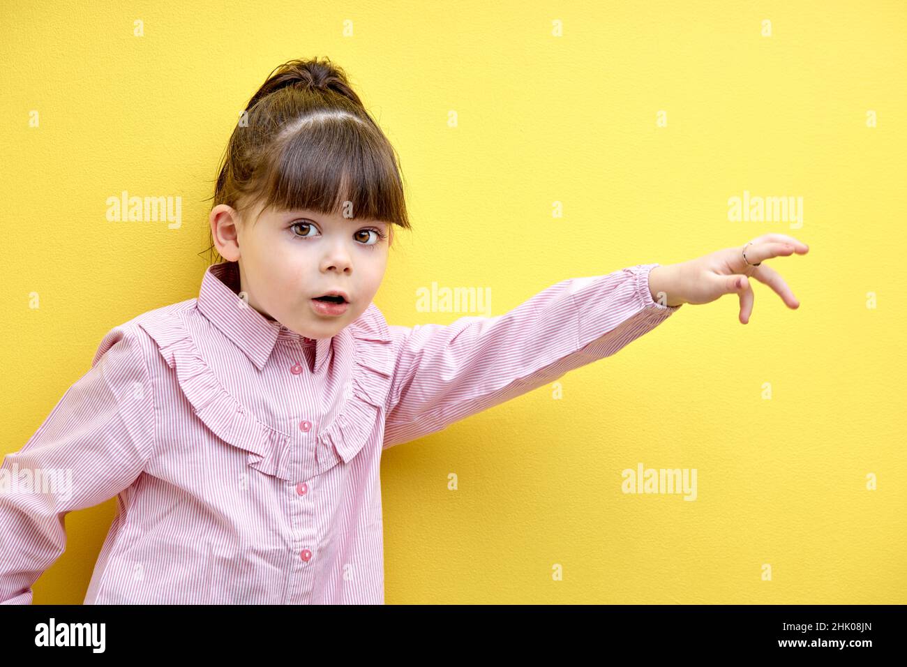 cute little kid girl scared and run expression gesture. isolated yellow ...