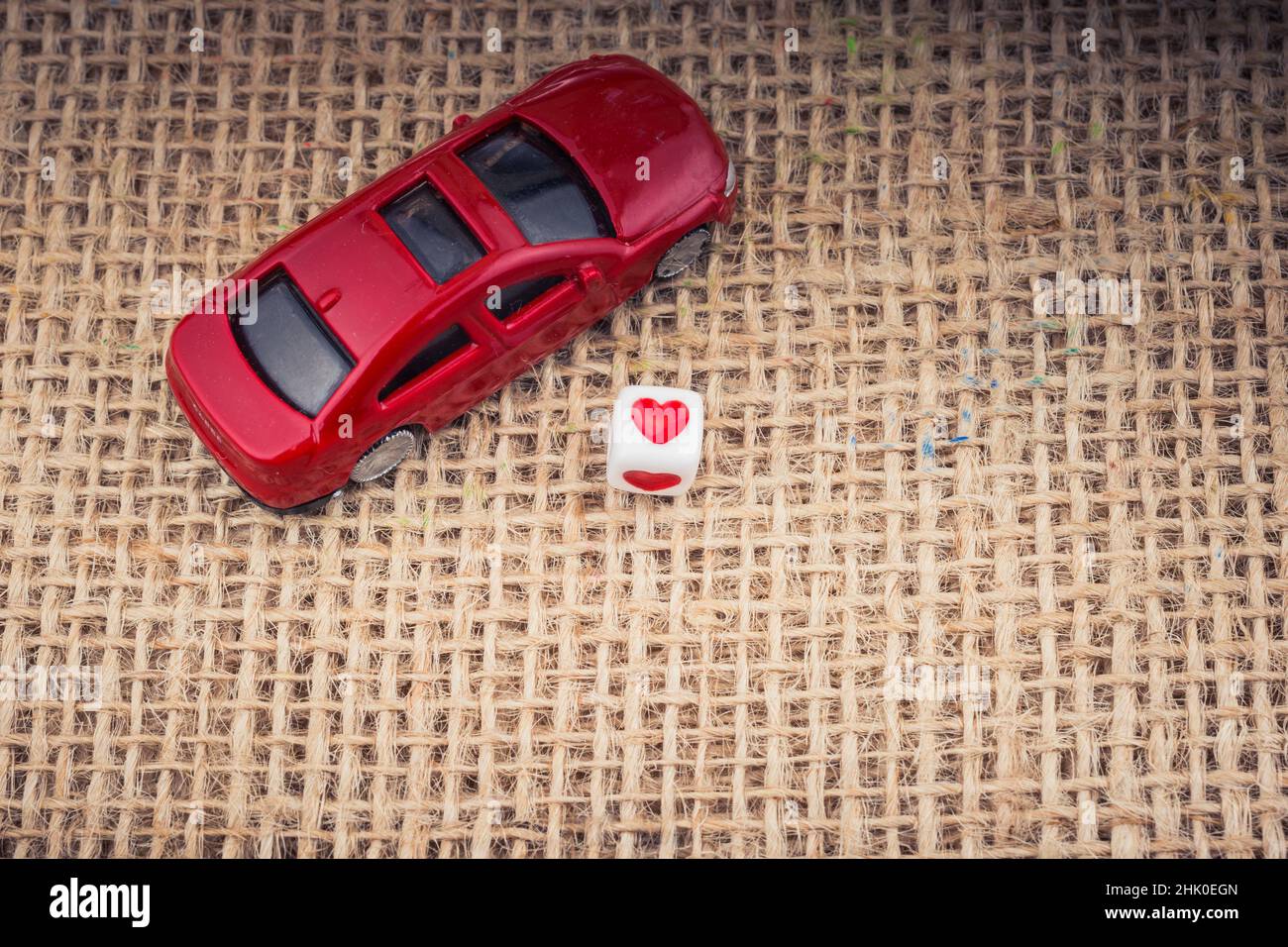 Love cube on a red toy car on a linen canvas Stock Photo - Alamy