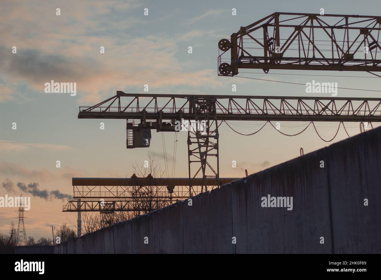Loading cranes, metalwork plant. Silhouettes of cranes on the ...