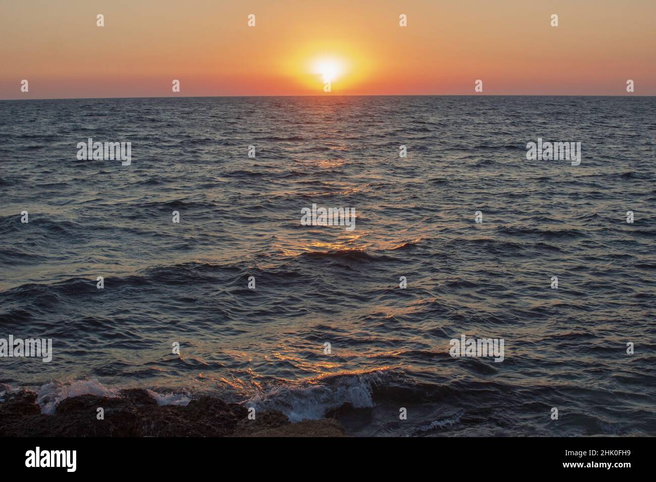The sun rises in the morning haze over the sea Stock Photo - Alamy