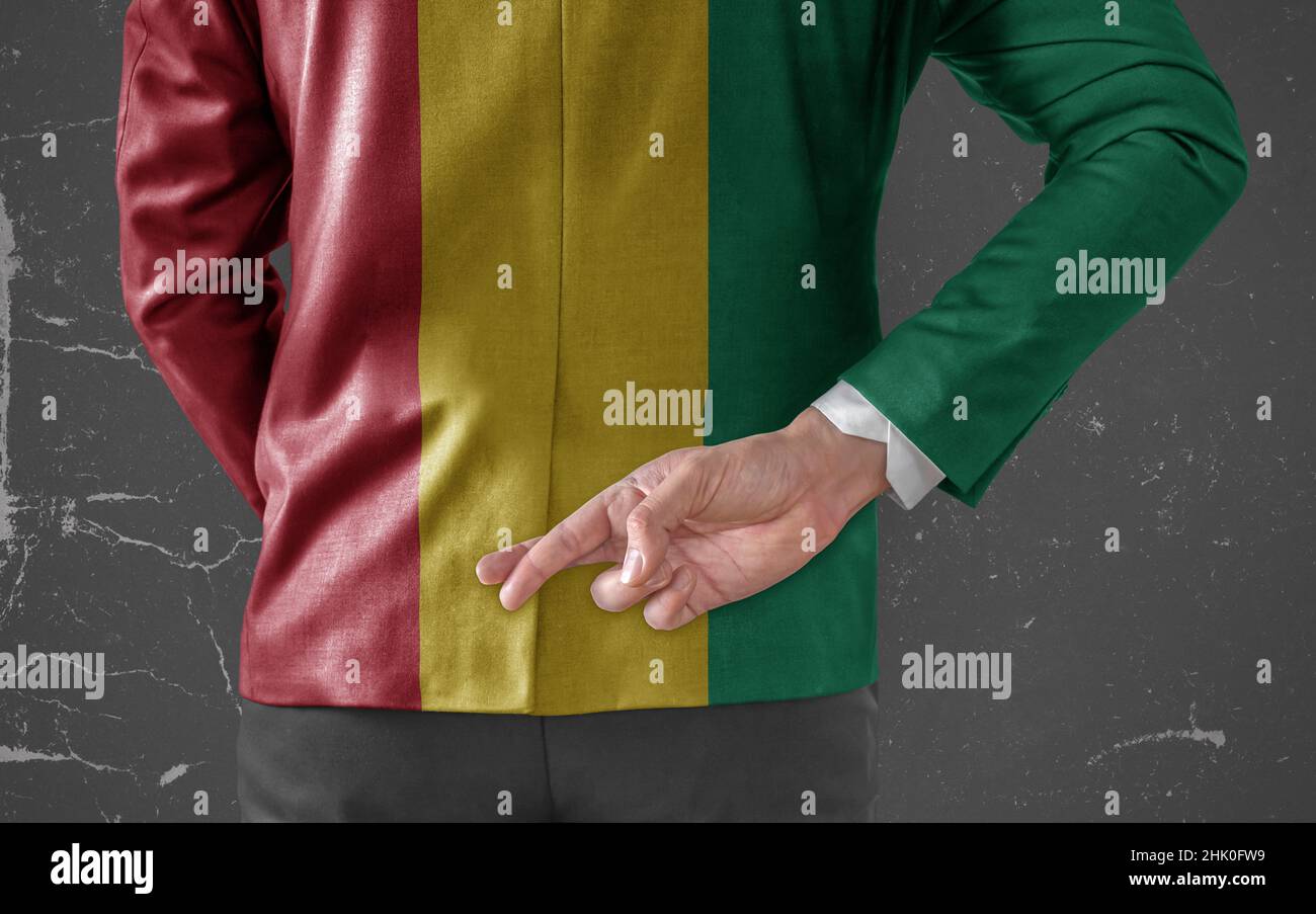 Businessman Jacket with Flag of Guinea with his fingers crossed behind ...