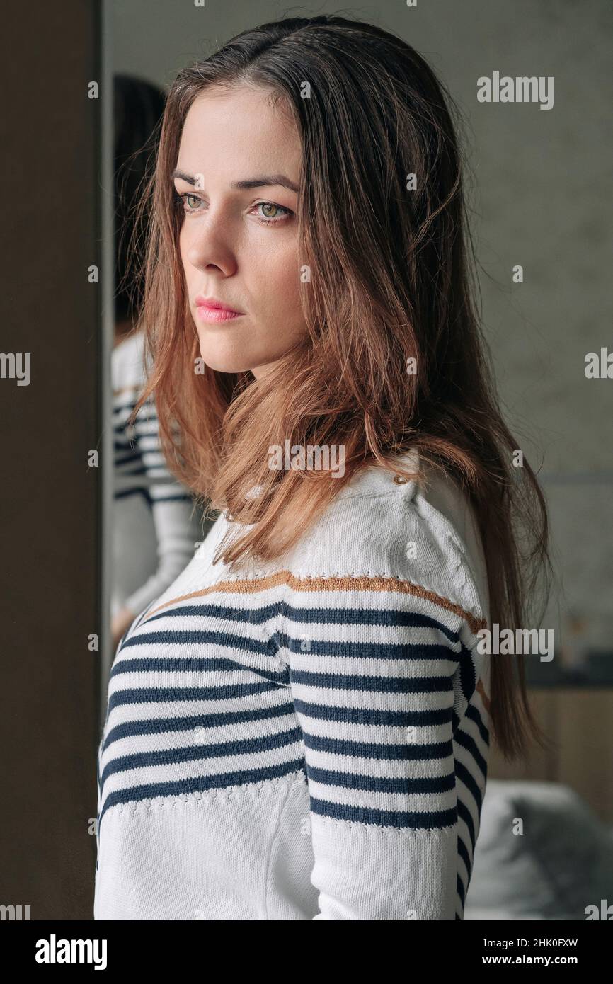 Woman of 36 looking out the window. Portrait of beautiful attractive ...