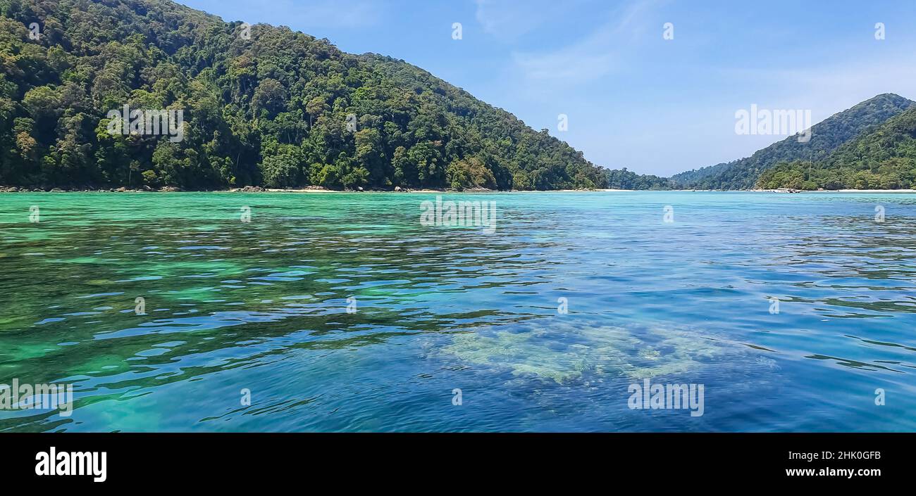 Emerald sea water and beautiful natural rocky seashore. Summer vacation ...