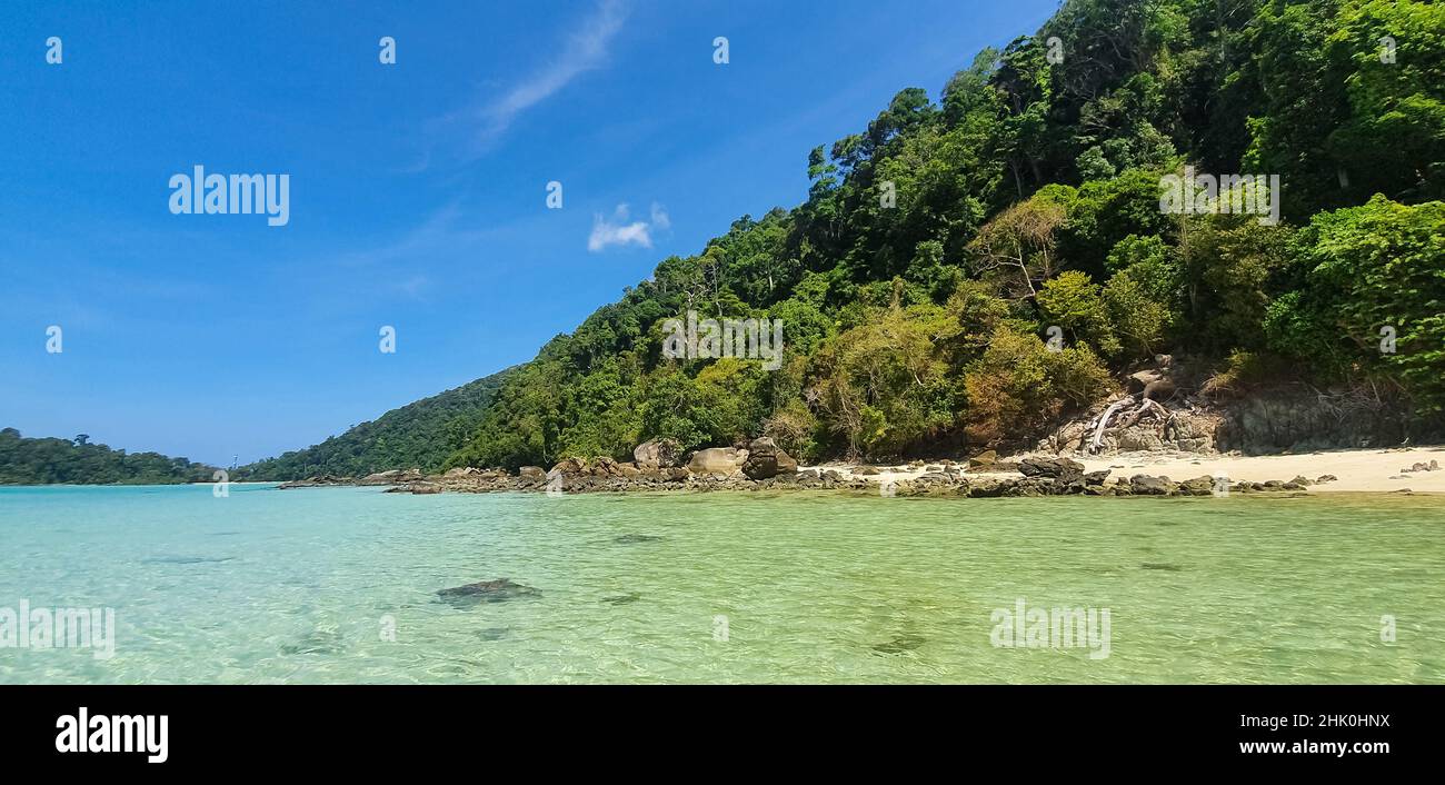 Emerald sea water and beautiful natural rocky seashore. Summer vacation ...