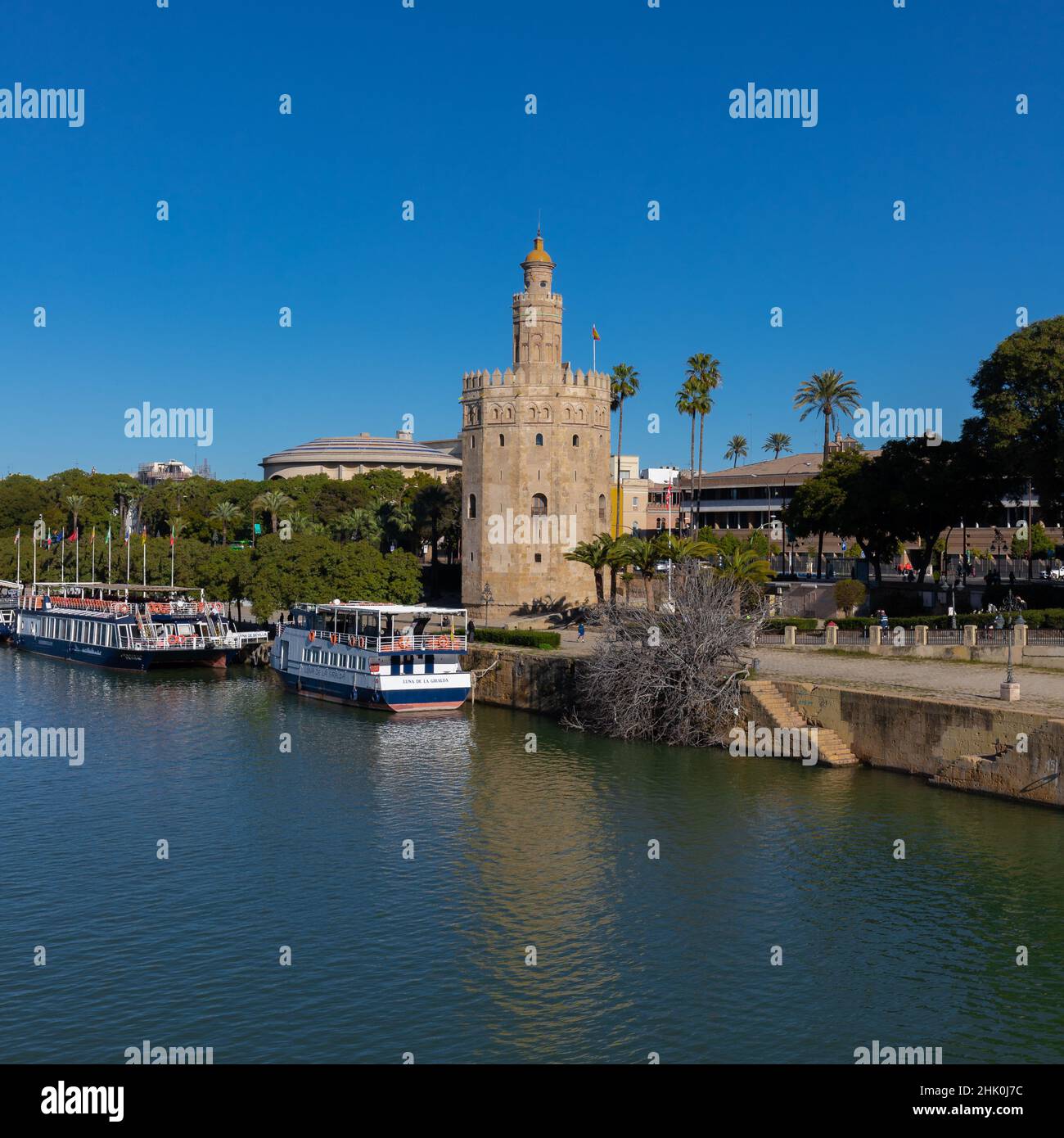 The golden tower in the Centre of Seville alongside the river. The ...