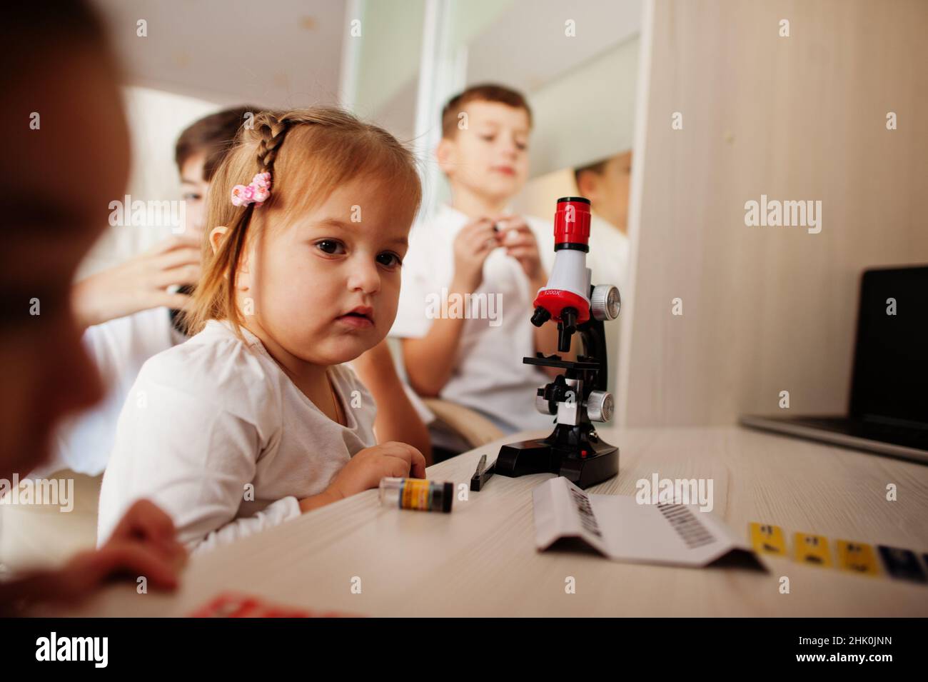 Kids using microscope learning science class at home Stock Photo - Alamy