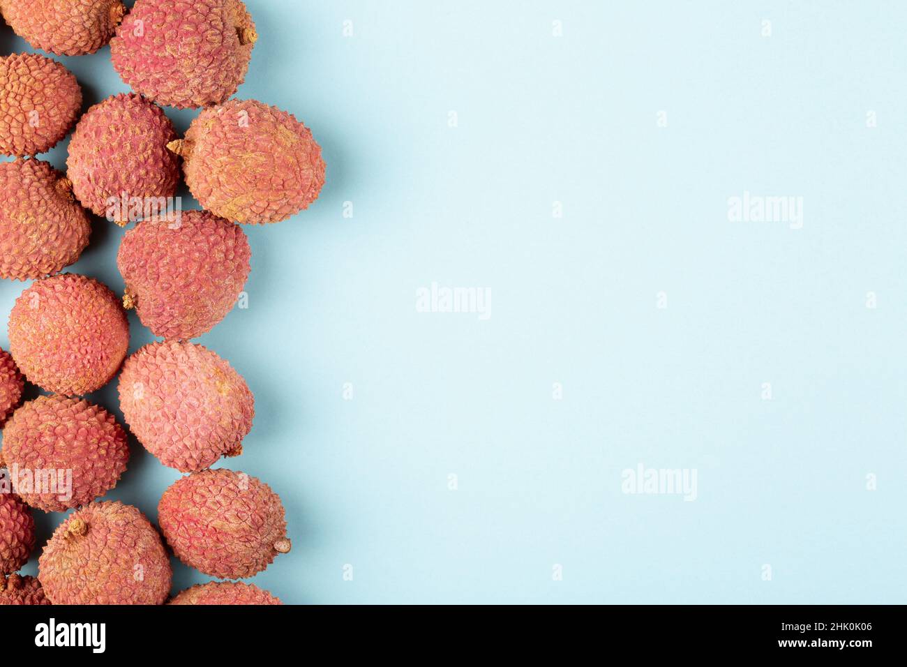 Lychee on a blue background, flat lay, copy space Stock Photo - Alamy