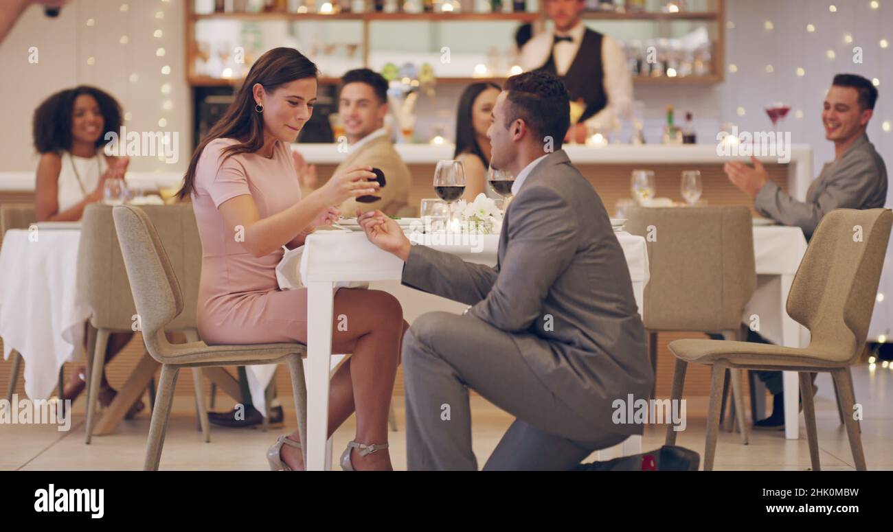 Everyone is applauding the happily engaged couple Stock Photo - Alamy