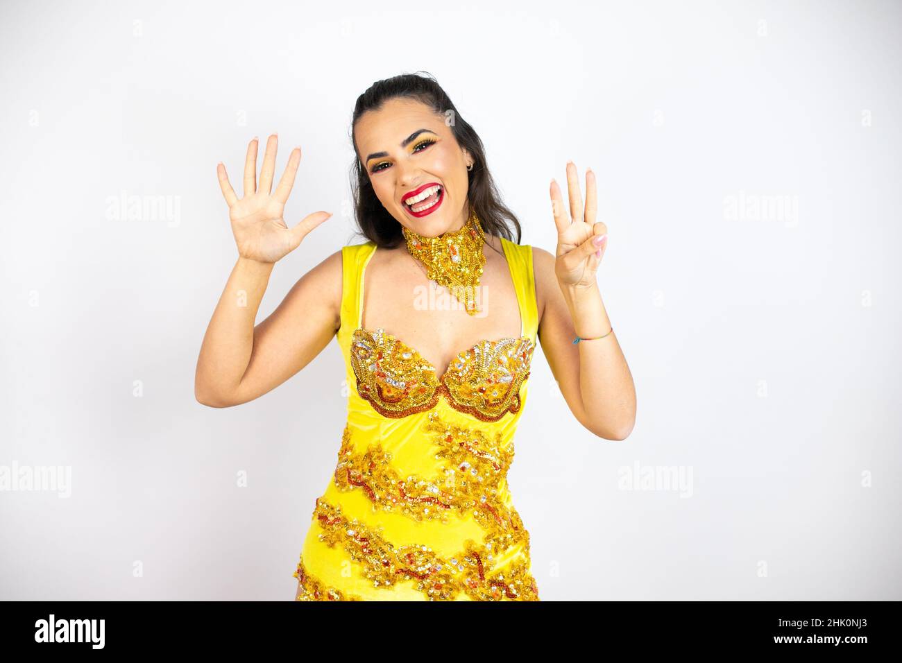 Young beautiful woman wearing carnival costume over isolated white ...