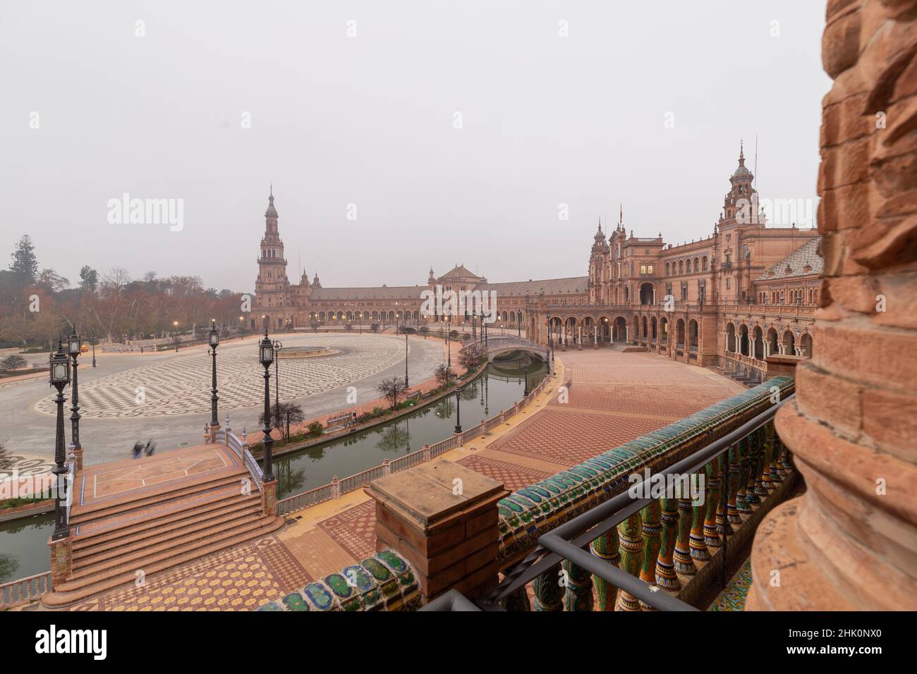 The famous Spanish square in Seville during a sunrise covered in fog ...