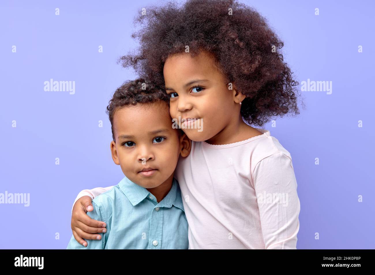 Portrait Of Two Curly Adorable Siblings Brother And Sister Hugging Each