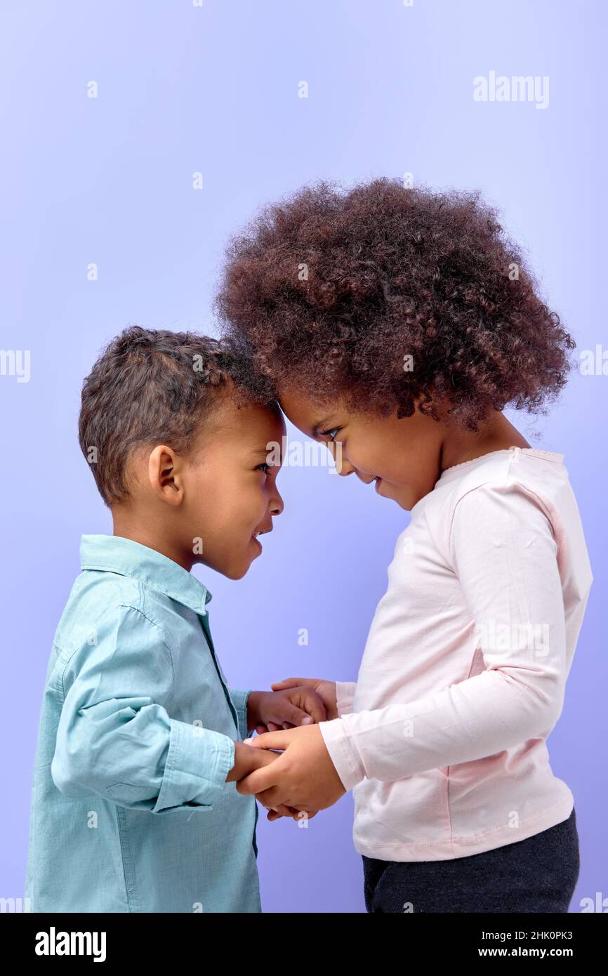 two lovely kid friends hugging holding hands together isolated over ...