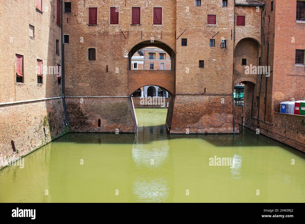 The moat of the famous medieval Este castle (Castello Estense) of ...