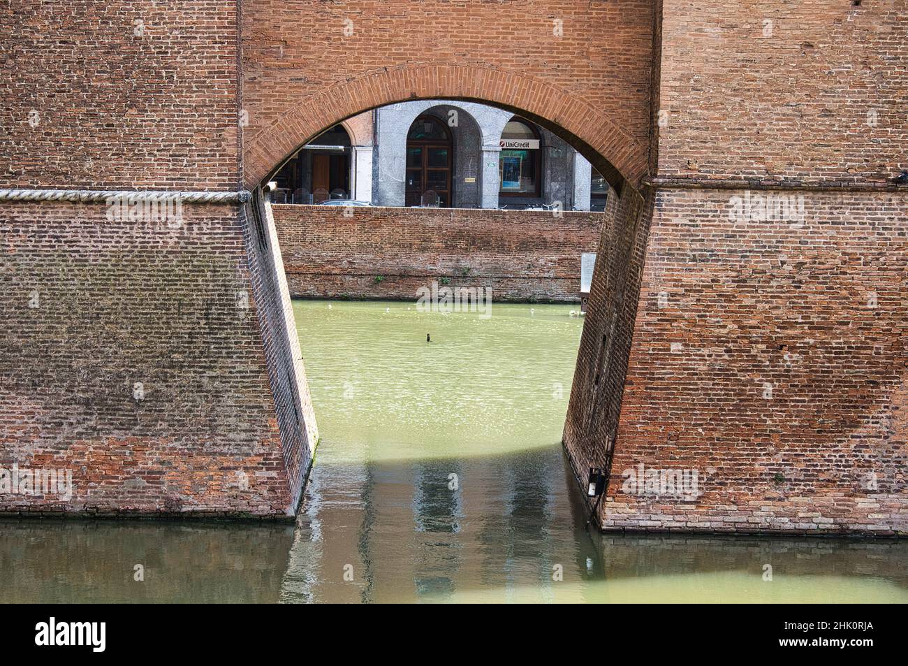The moat of the famous medieval Este castle (Castello Estense) of ...