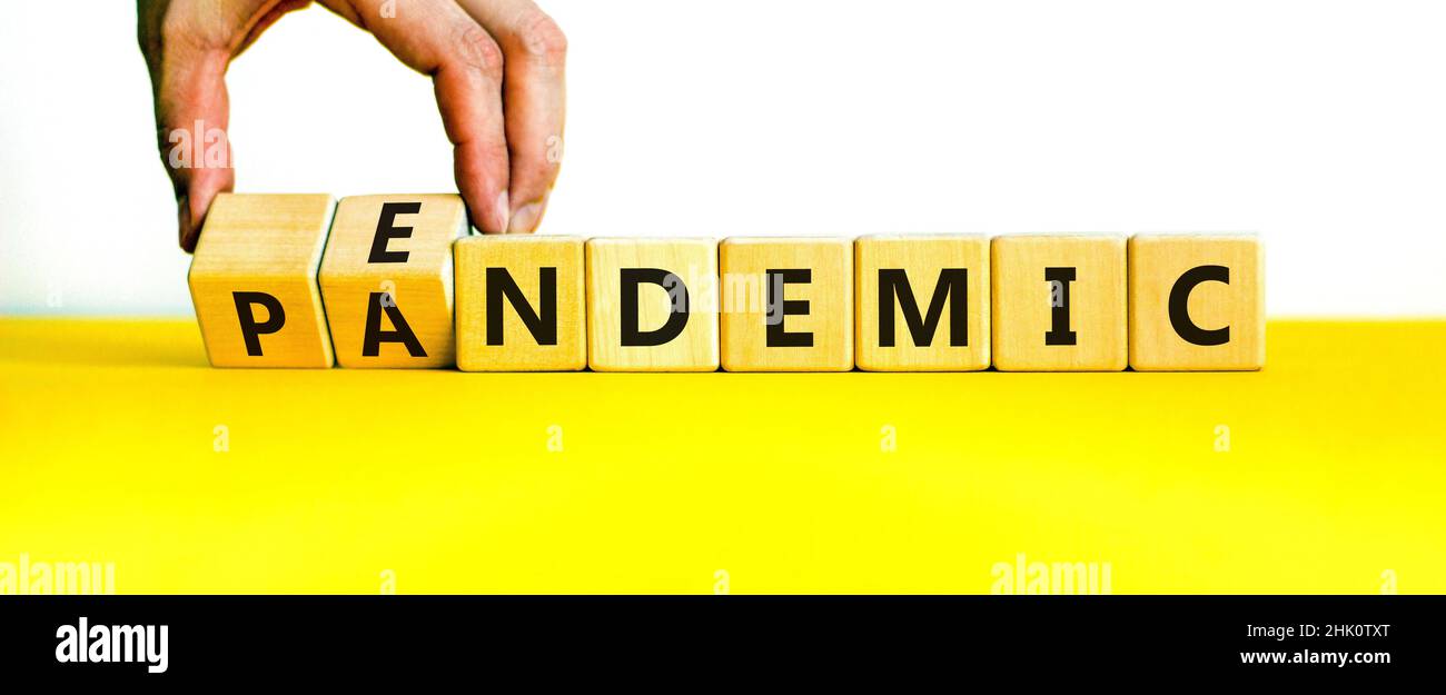 Covid-19 pandemic or endemic symbol. Doctor turns wooden cubes and ...