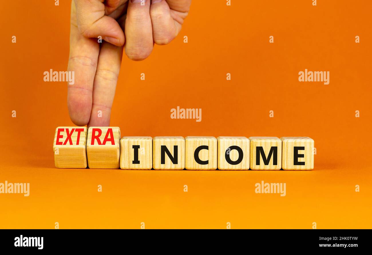 Extra income symbol. Businessman turns wooden cubes and changes concept ...