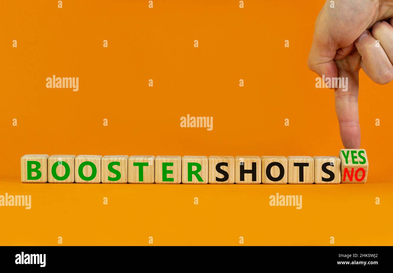Covid-19 booster vaccine shots yes or no symbol. Doctor turns cubes ...
