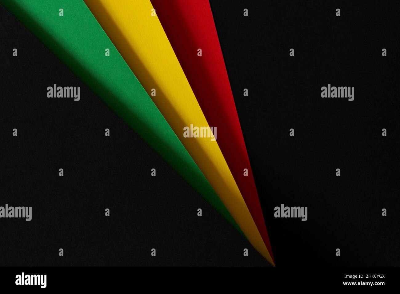 Abstract geometric black, red, yellow, green color paper background ...