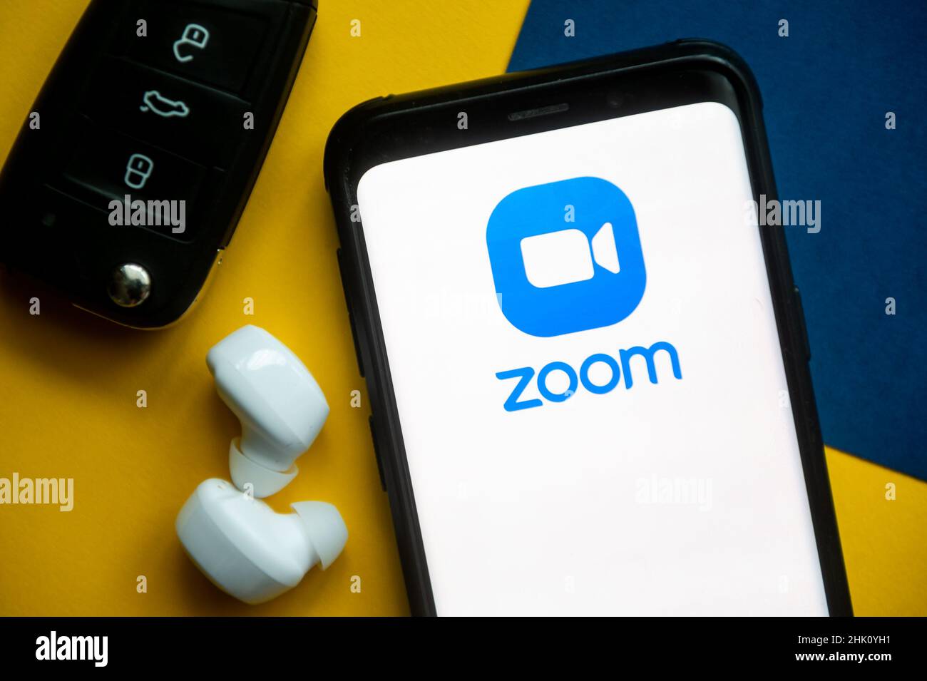 In this photo illustration a Zoom logo seen displayed on a smartphone ...