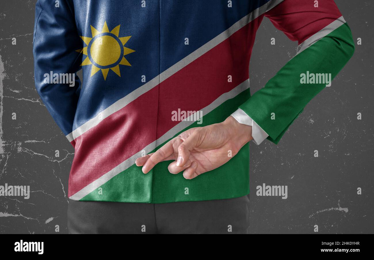 Businessman Jacket with Flag of Namibia with his fingers crossed behind ...