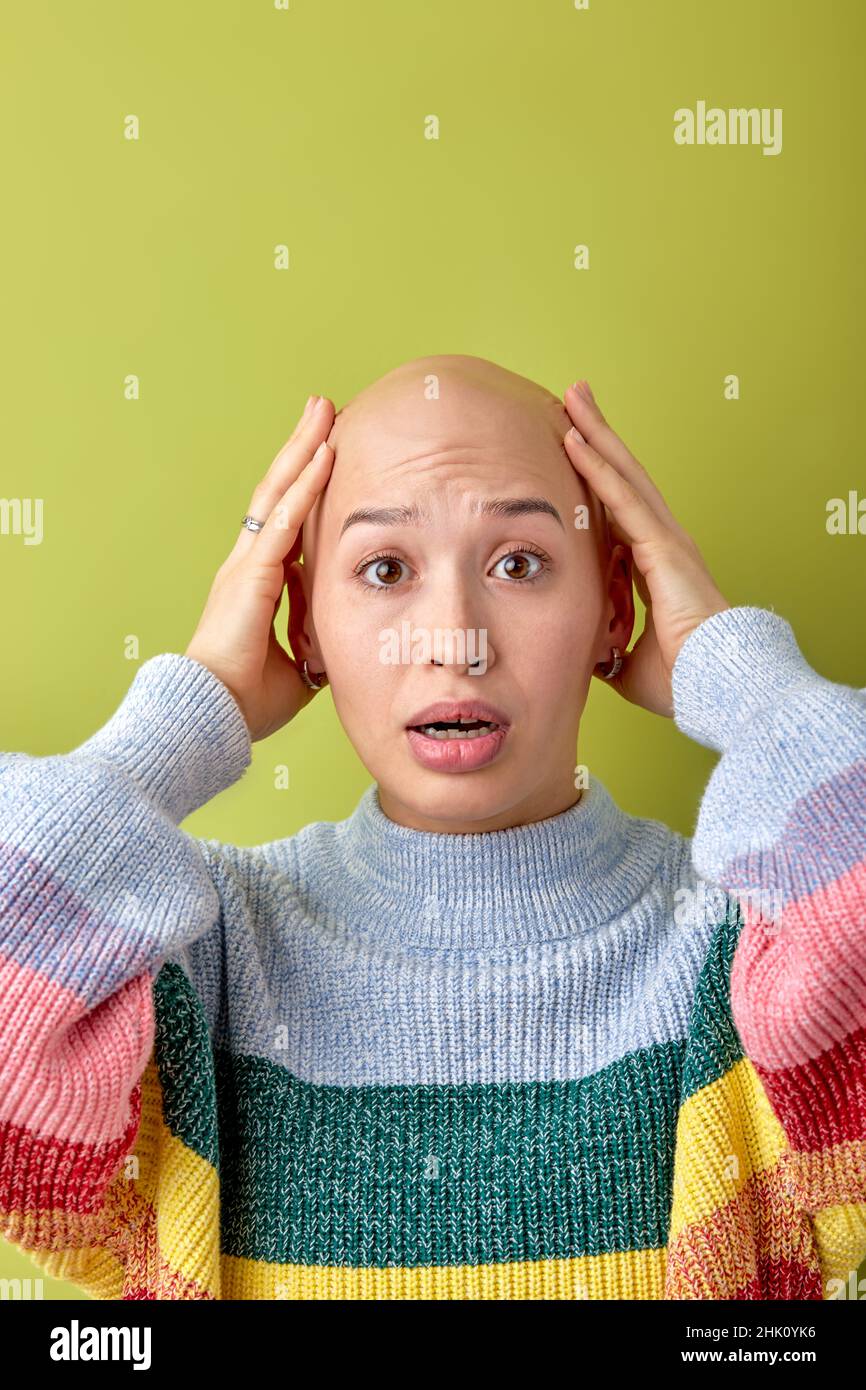 Shocked female touching head by surprise, looking at camera with opened ...