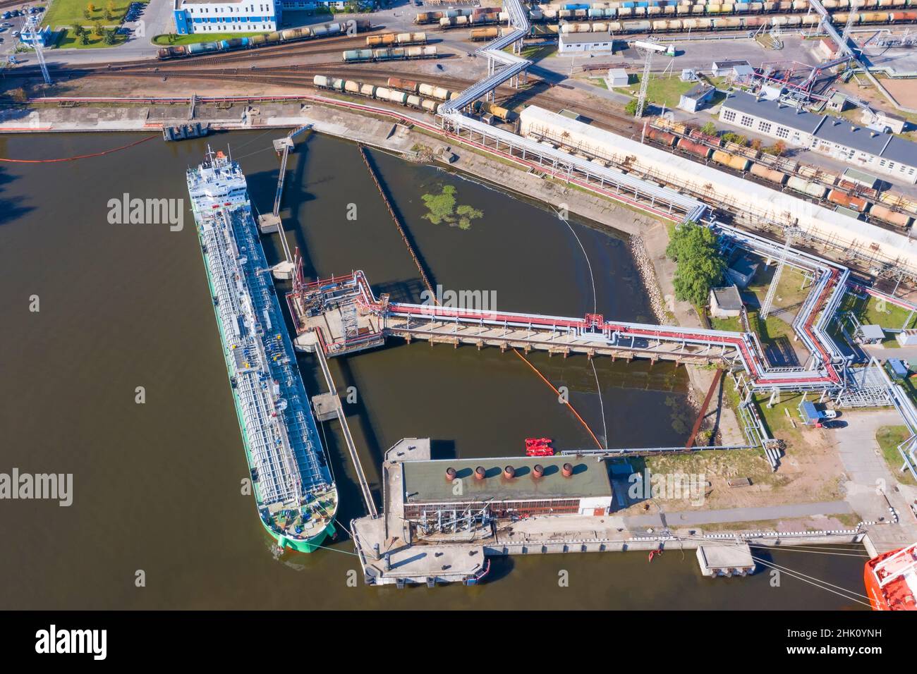 Aerial top view tanker at unloading in a large bulk port liquid cargo ...