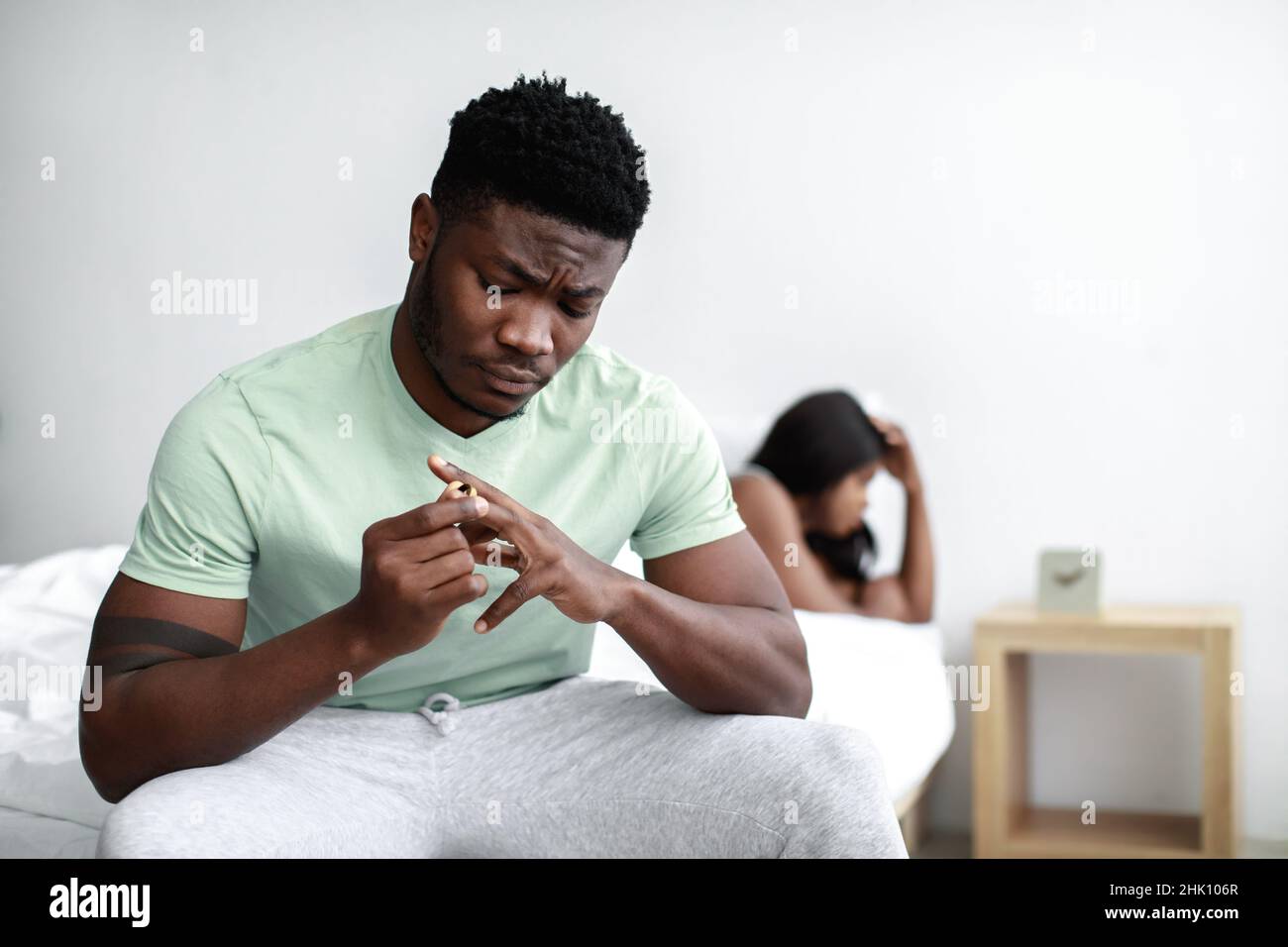Unhappy Sad Millennial African American Guy Takes Off Wedding Ring