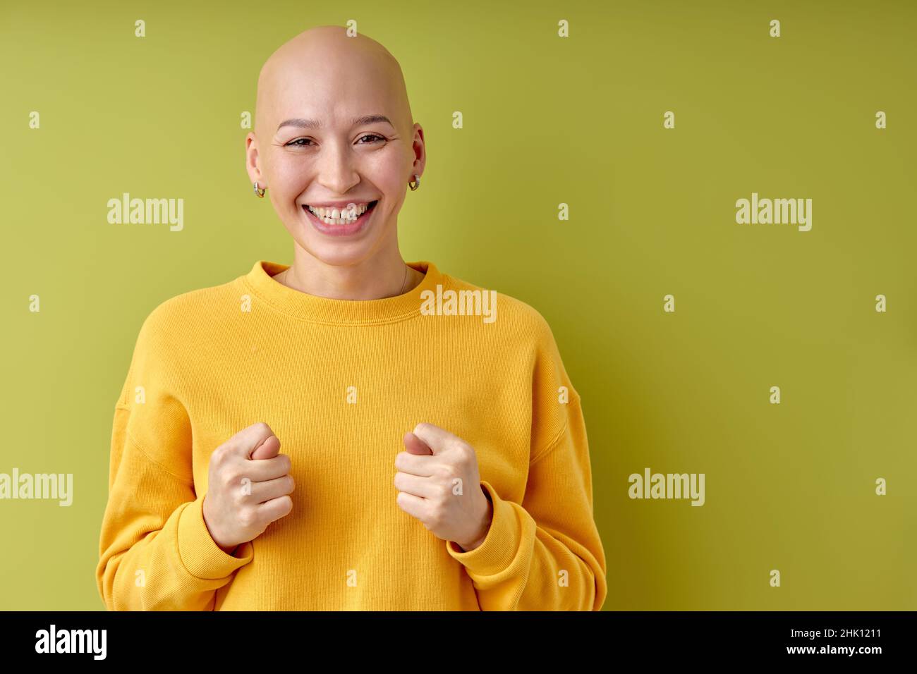 bald happy lady in yellow shirt showing fig gesture, you dont get it ...