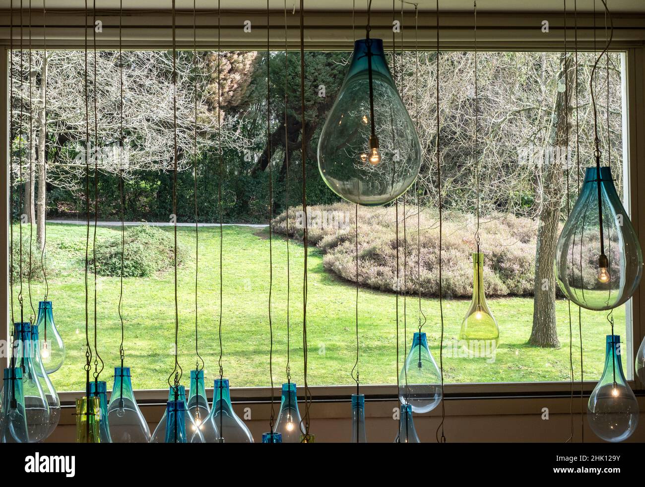 Light bulbs hanging in front of a window Stock Photo - Alamy
