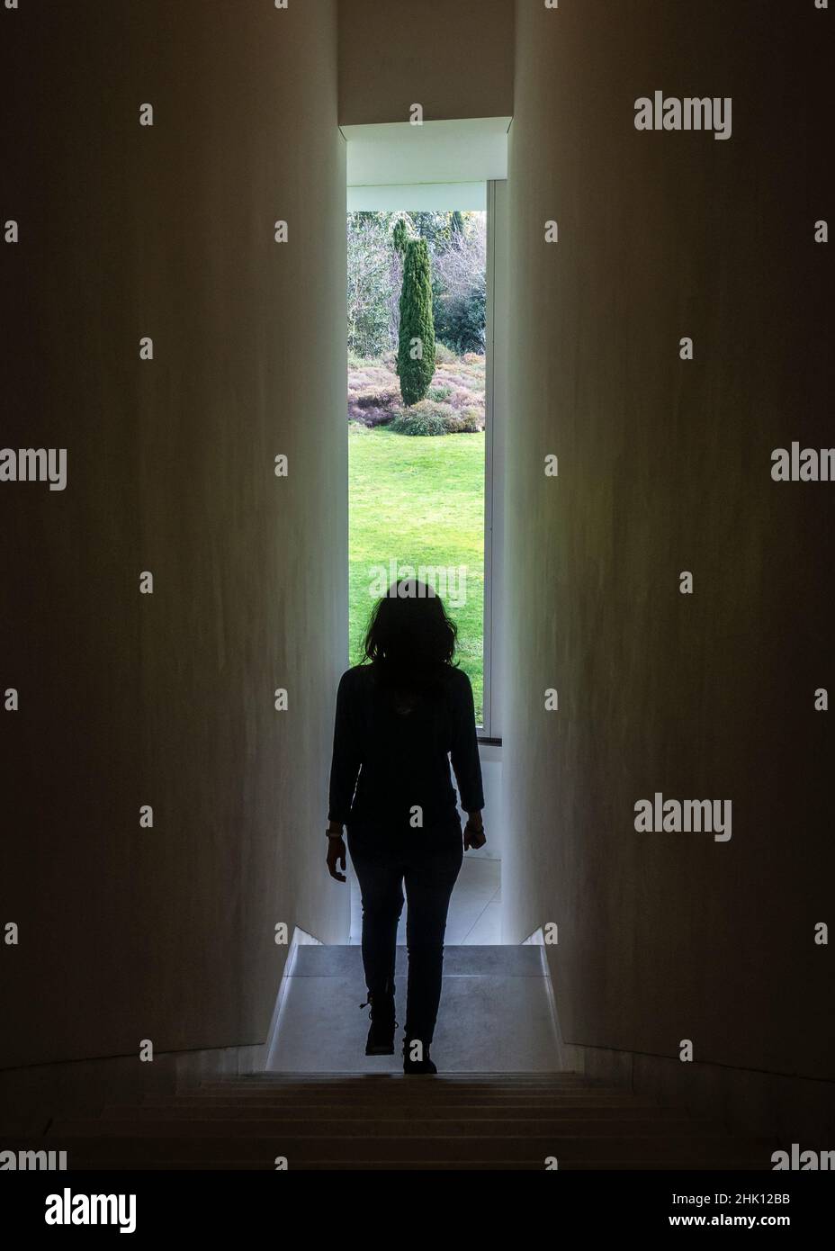 Young girl walking through a narrow corridor of a museum Stock Photo ...