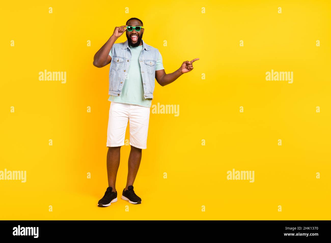 Full length body size view of handsome trendy cheery guy showing copy ...