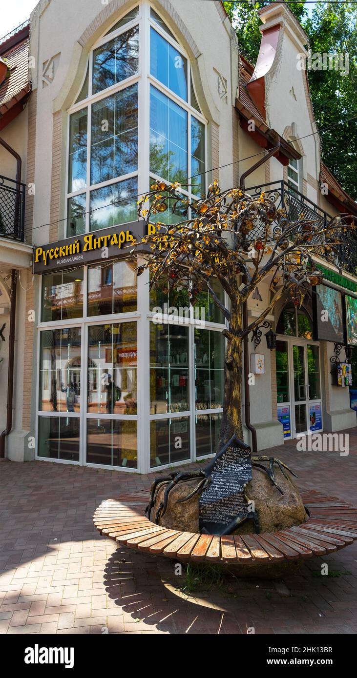 Bronze statue of an apple tree with apples made of amber next to the ...