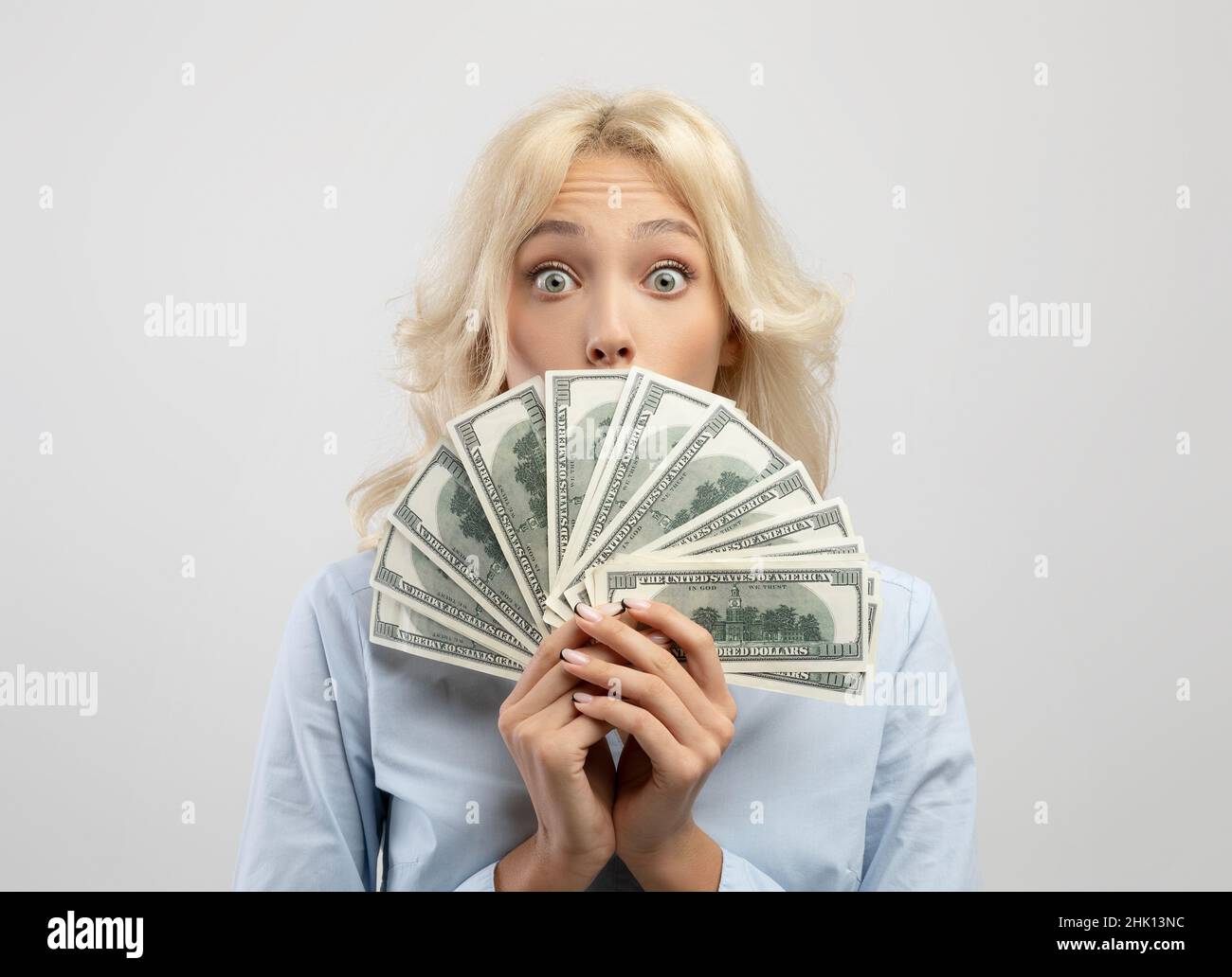 Shocked businesswoman covering her face with money, hiding face behind ...
