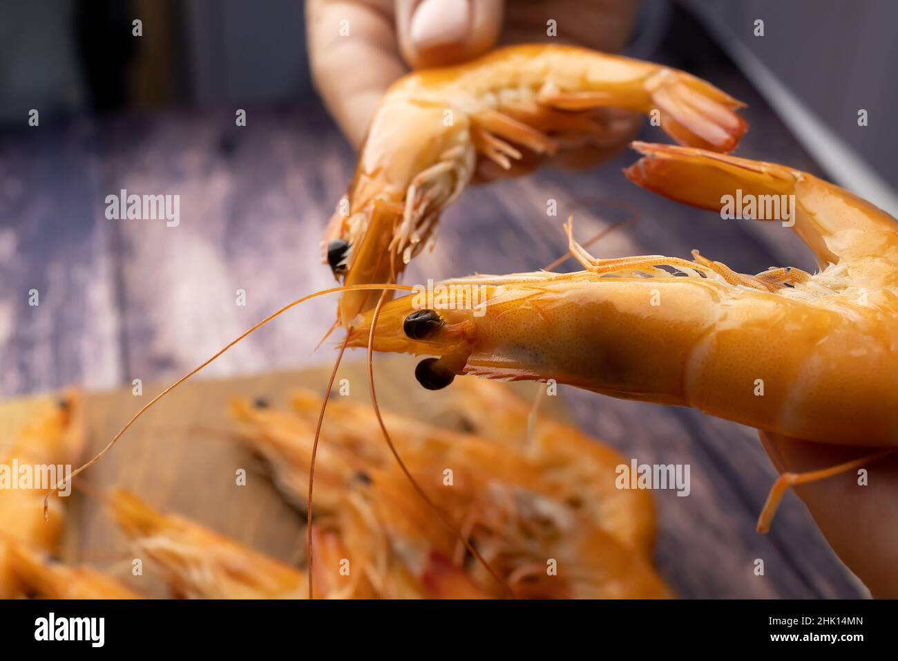 top view of the boiled shrimp that are held in their hands leaning ...