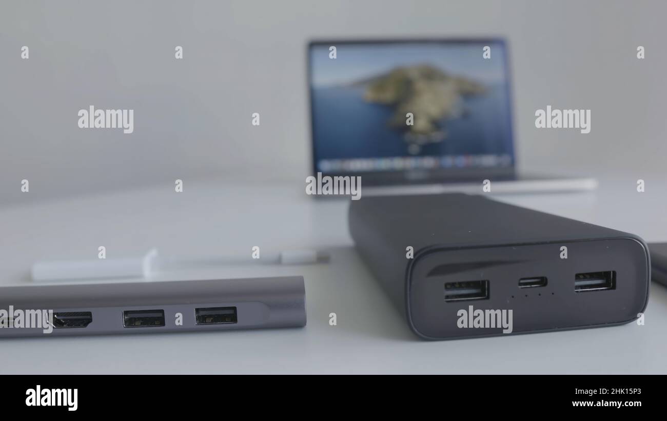 Set of external batteries on background of laptop. Action. Close-up of ...