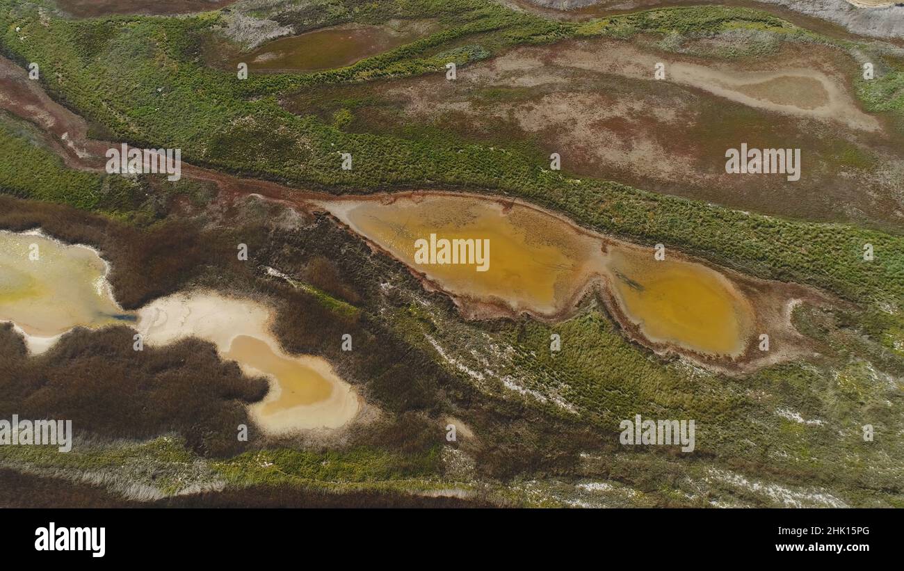 Top view of patterned dirty water from swamp. Shot. Acid brown water ...