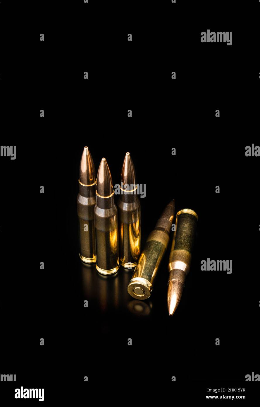 Bullet isolated on black background with reflexion. Rifle bullets close ...