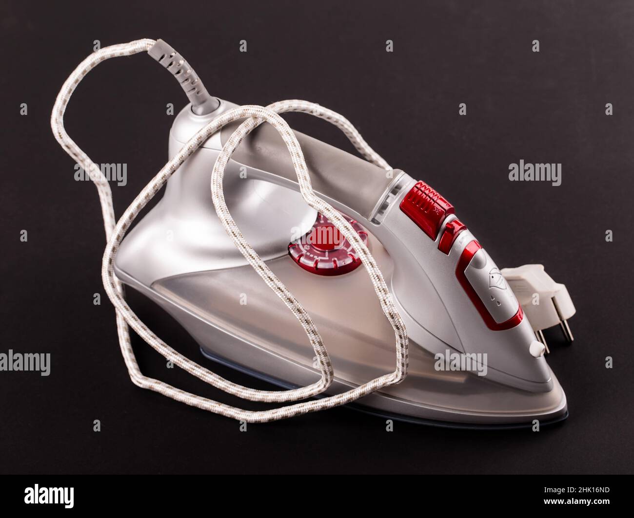 Plastic modern iron. Located on a black background Stock Photo - Alamy