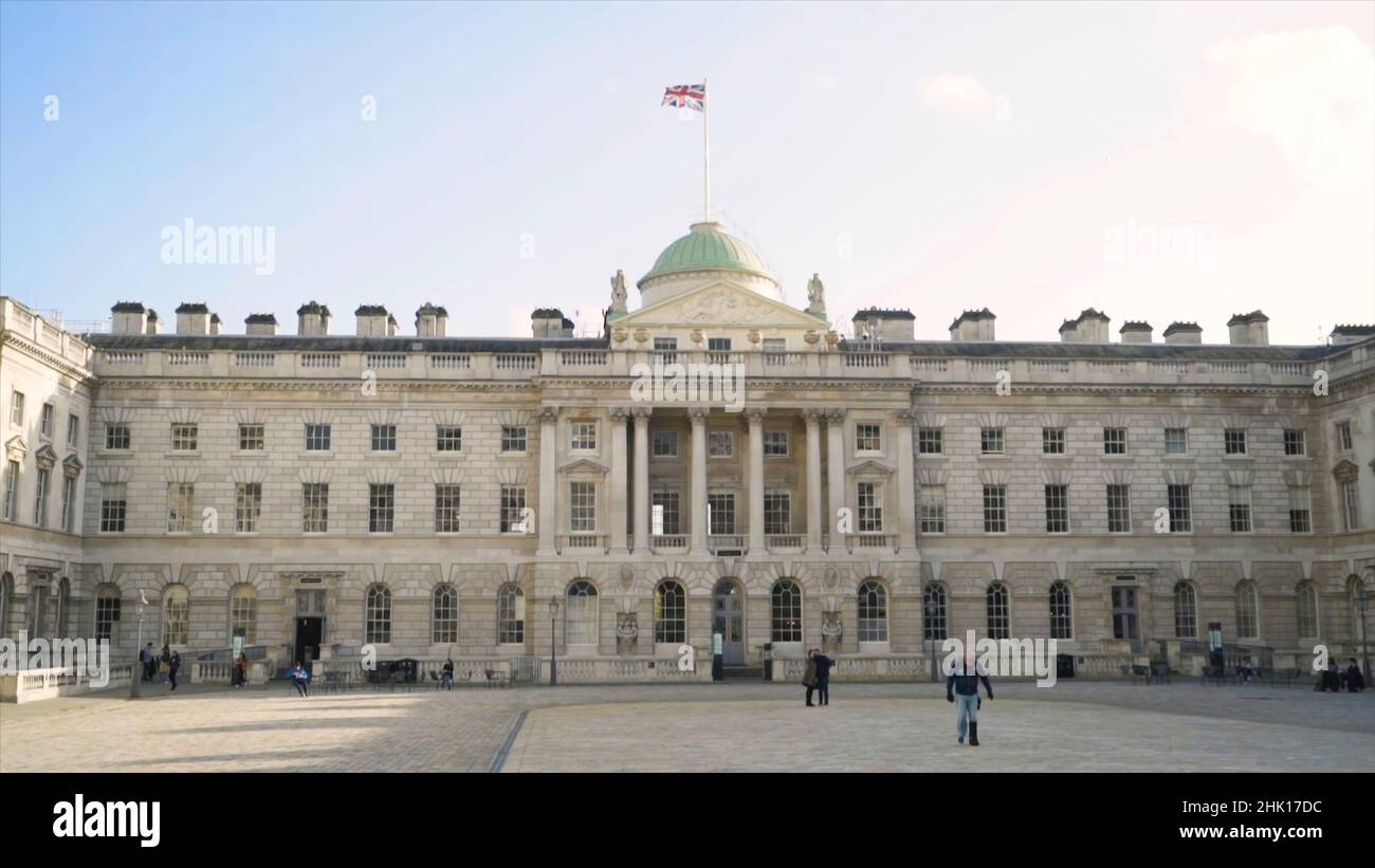 Courtyard inside white Palace. Action. Tourists walk in square on ...