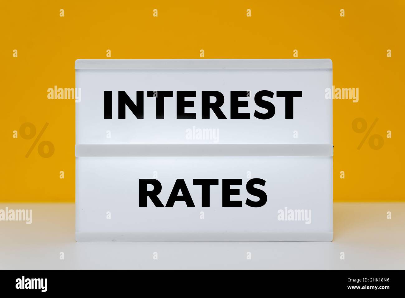 Interest rates on white box with yellow background Stock Photo - Alamy