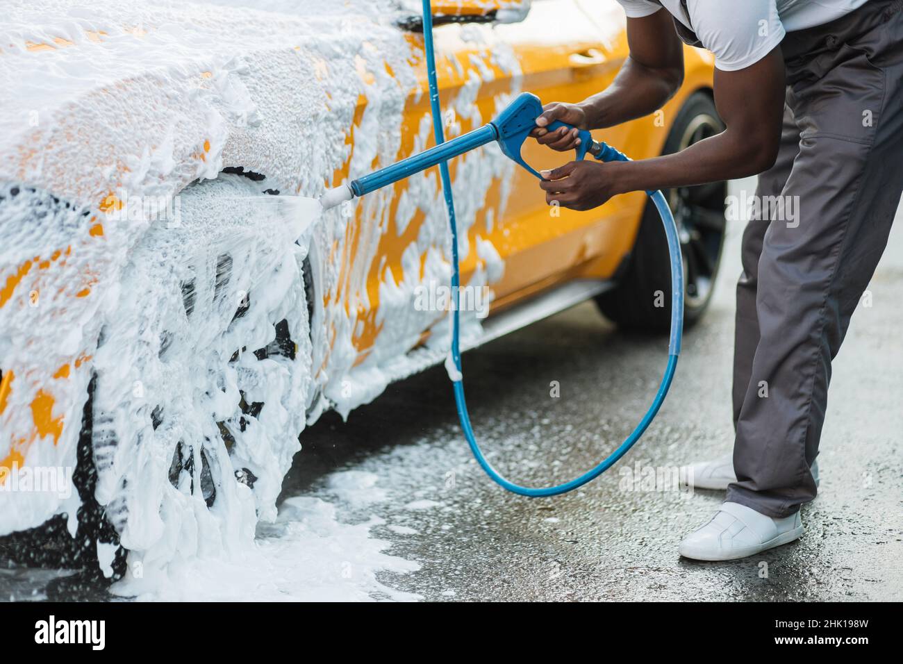 Car washing outdoors. Crop close up of car washing high pressure foam ...