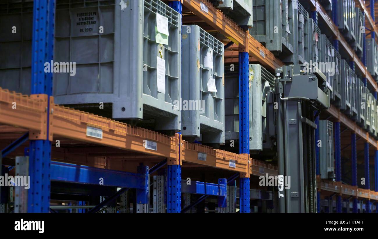 Working in factory warehouse. Scene. Technology for placing containers ...