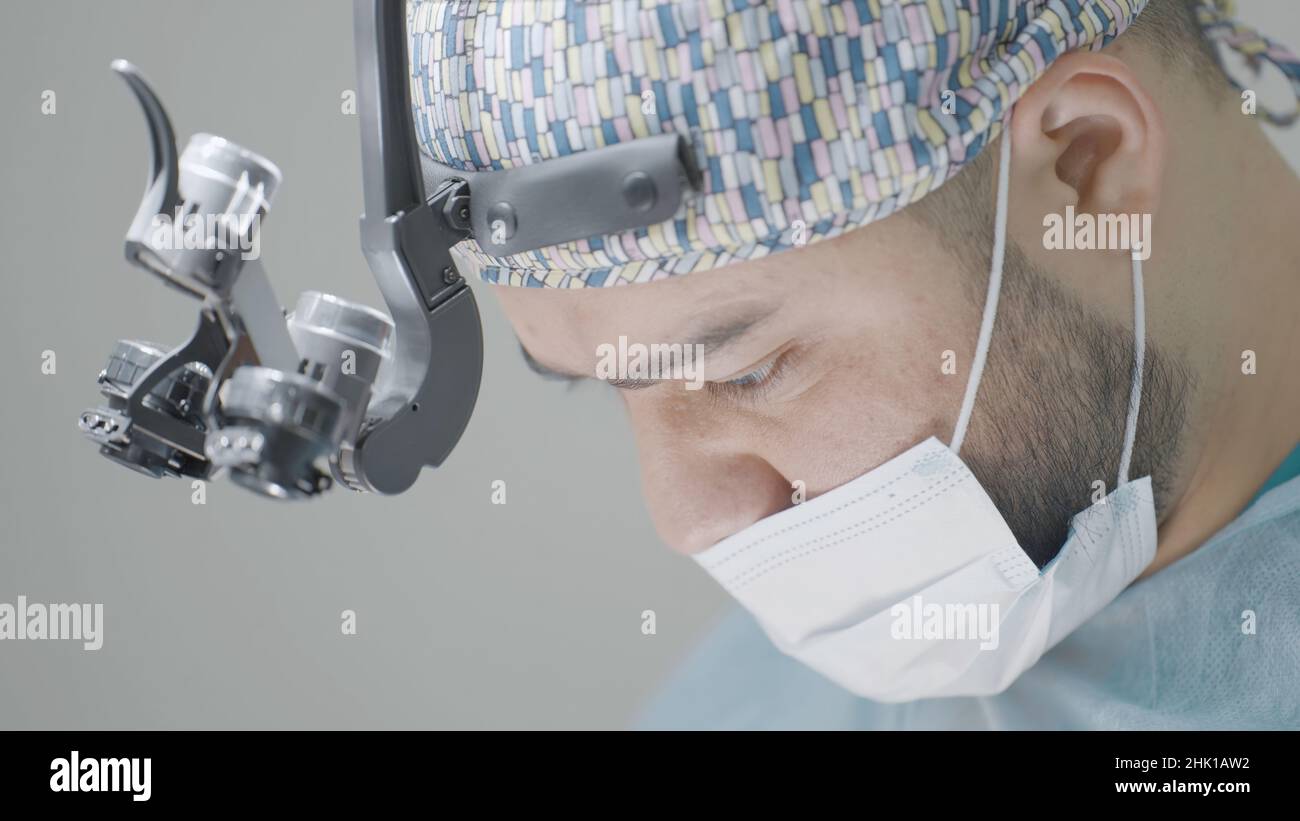 Close-up of surgeon performing operation. Action. Attentive and focused ...