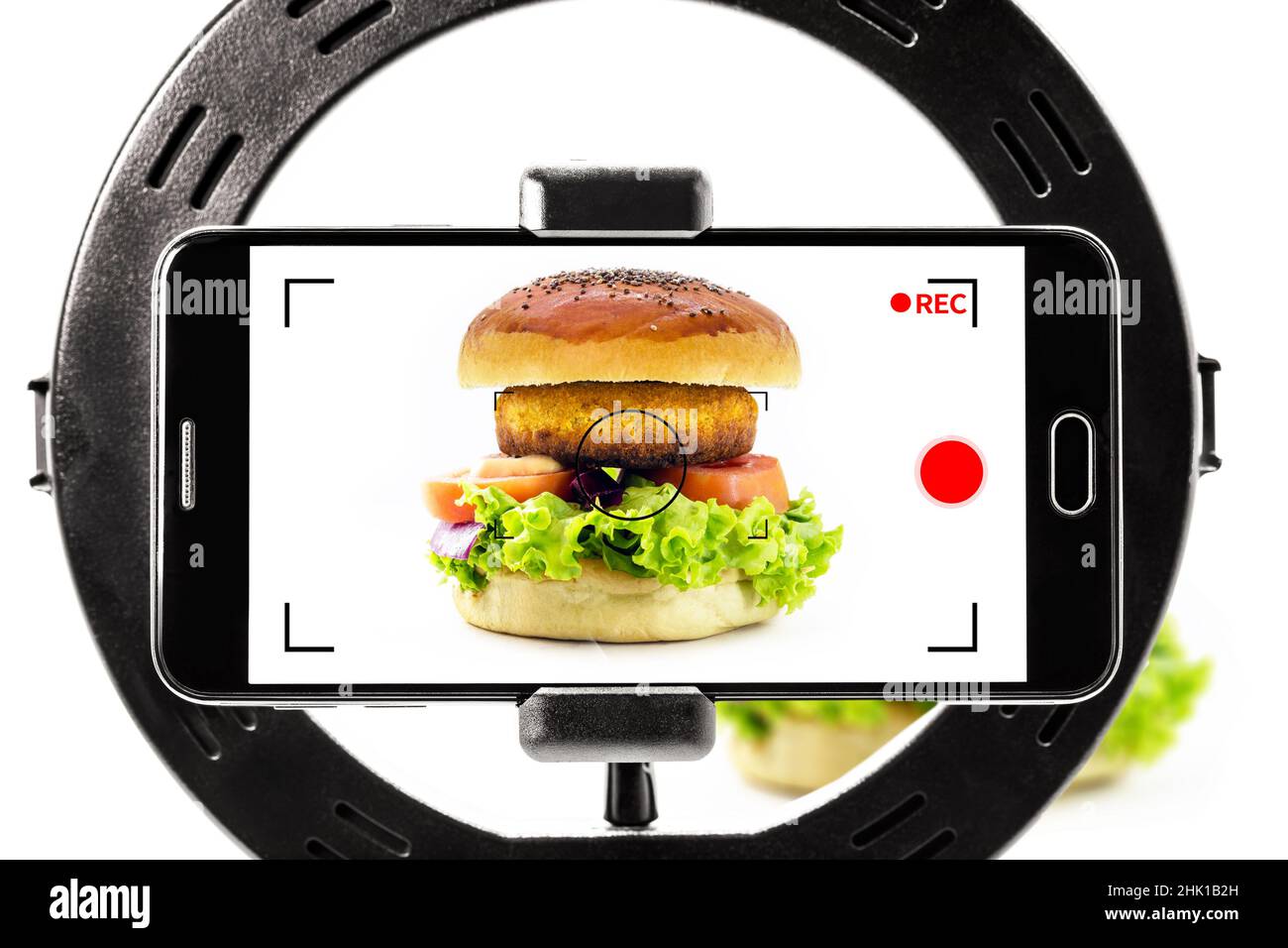 smartphone streaming video of hamburger, snack image being recorded for ...